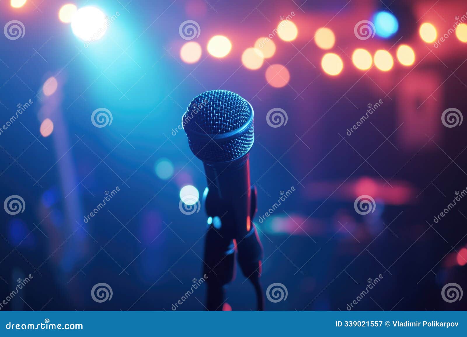 A Microphone on a Stand in Front of a Stage, Ready for Performance or ...