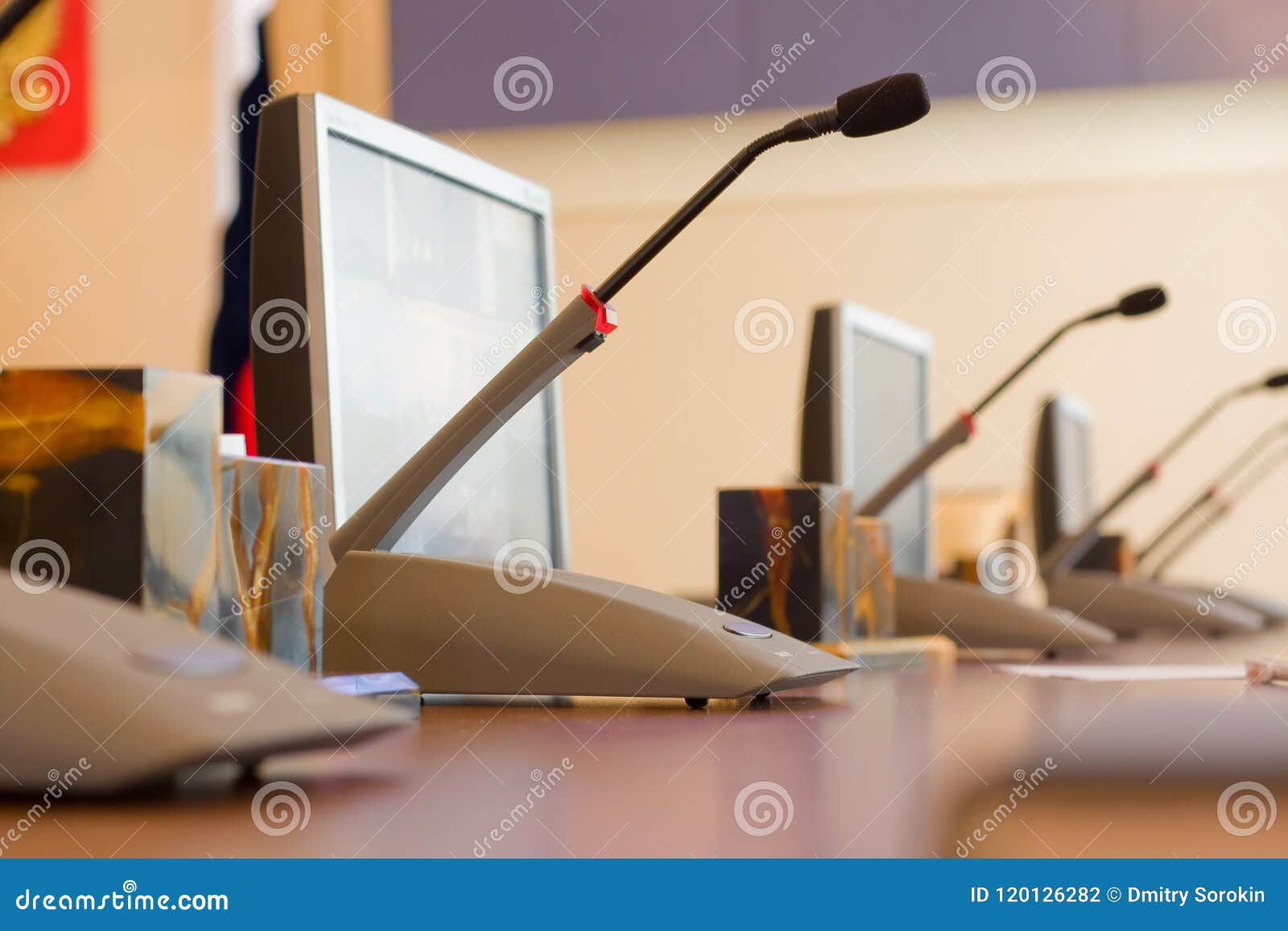 Microphones on a Table in a Boardroom Against a Background of Computer ...