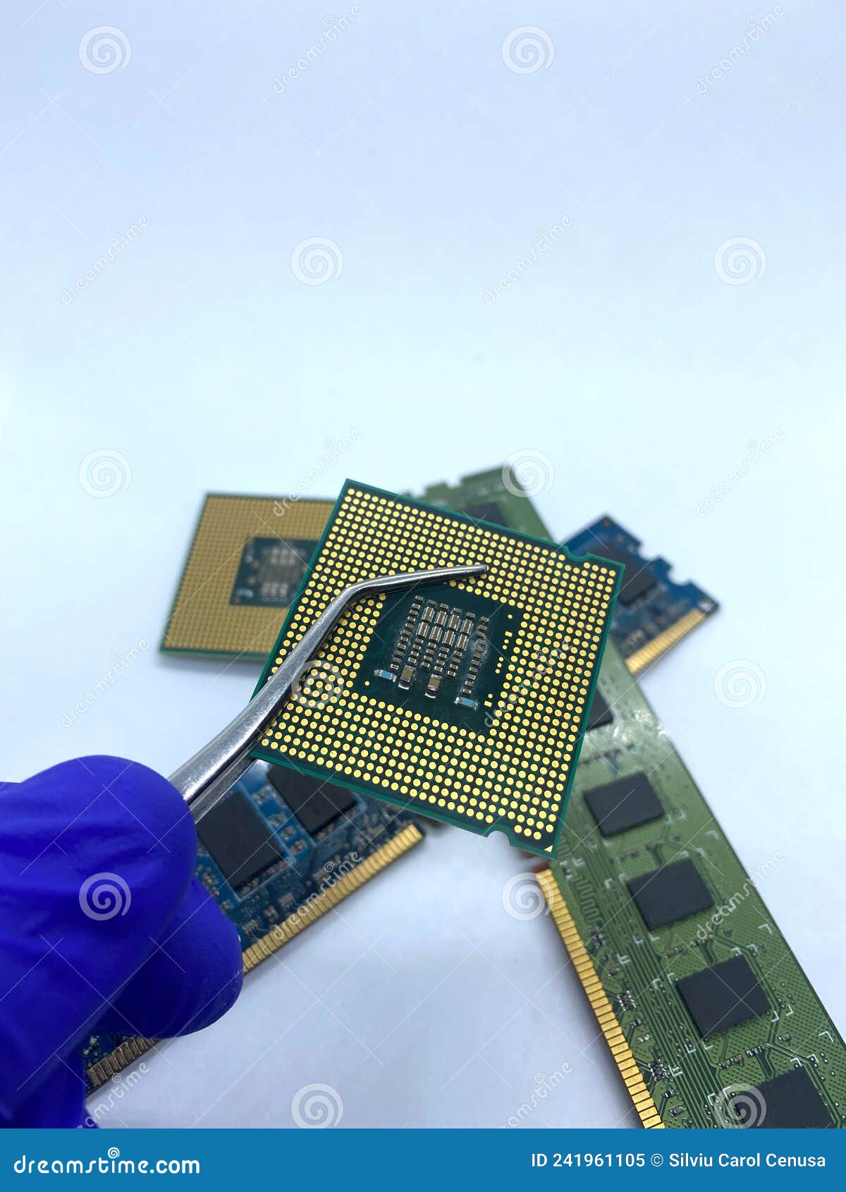 Microprocessor CPU Kept on Pincer Closeup View Against Other Computer ...