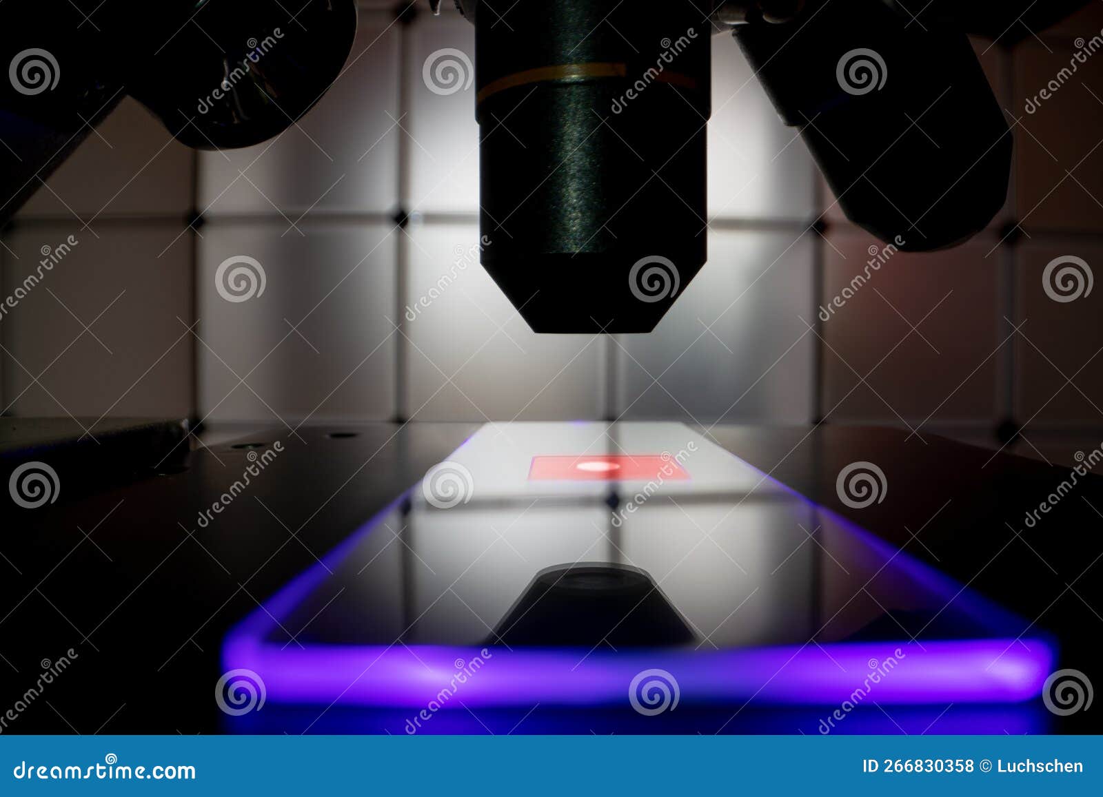 Microscope Table with a Luminous Slide and a Microscope Lens on a Dark ...