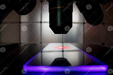 Microscope Table with a Luminous Slide and a Microscope Lens on a Dark ...