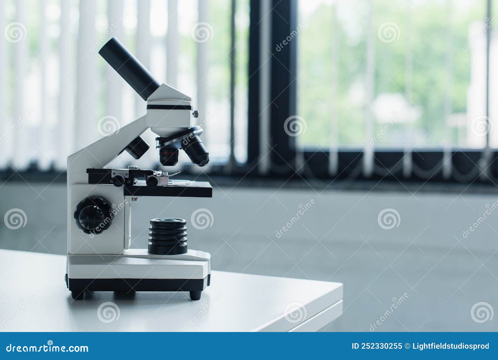 Microscope on White Table in Blurred Stock Image - Image of science ...