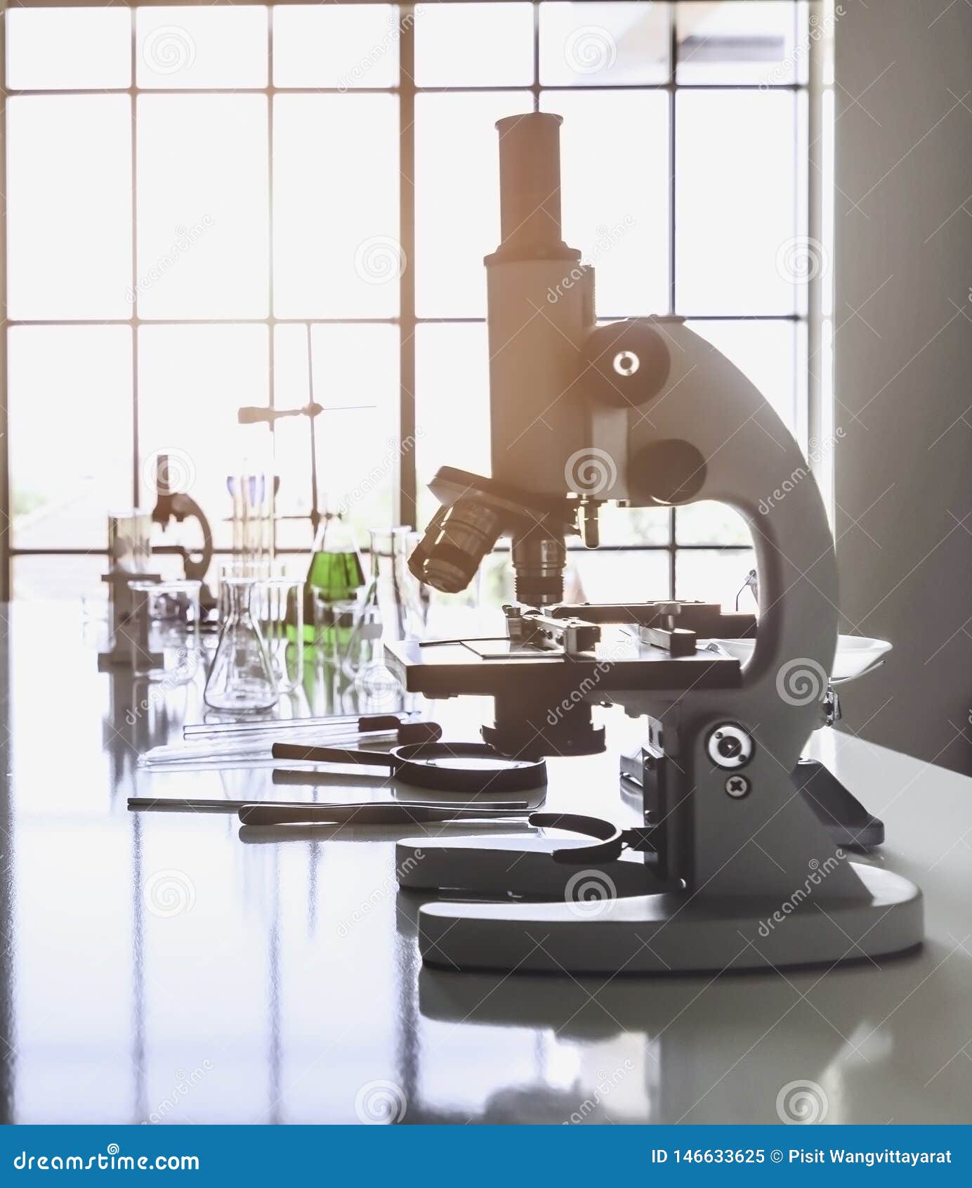 Microscopes and Lab Glassware on the Table in the Lab Along with ...