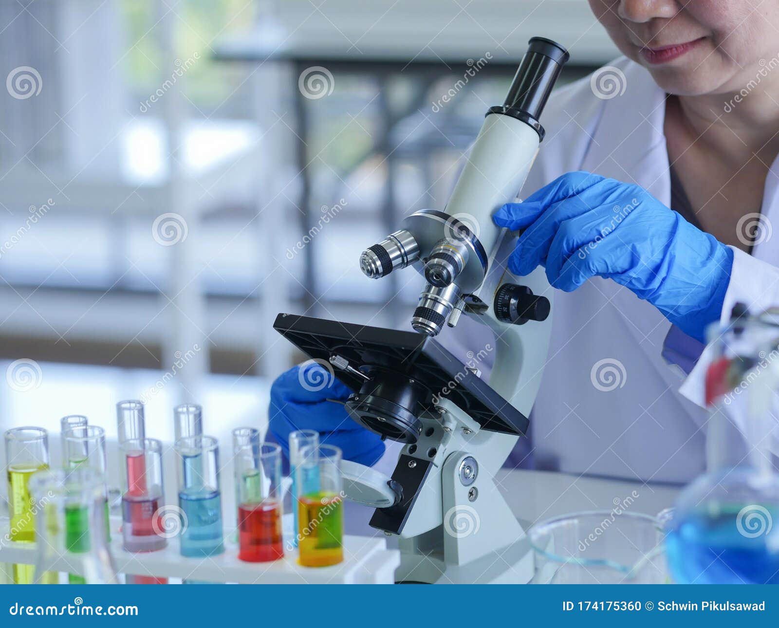 Female Scientist Adjusting the Microscope Stock Photo - Image of ...