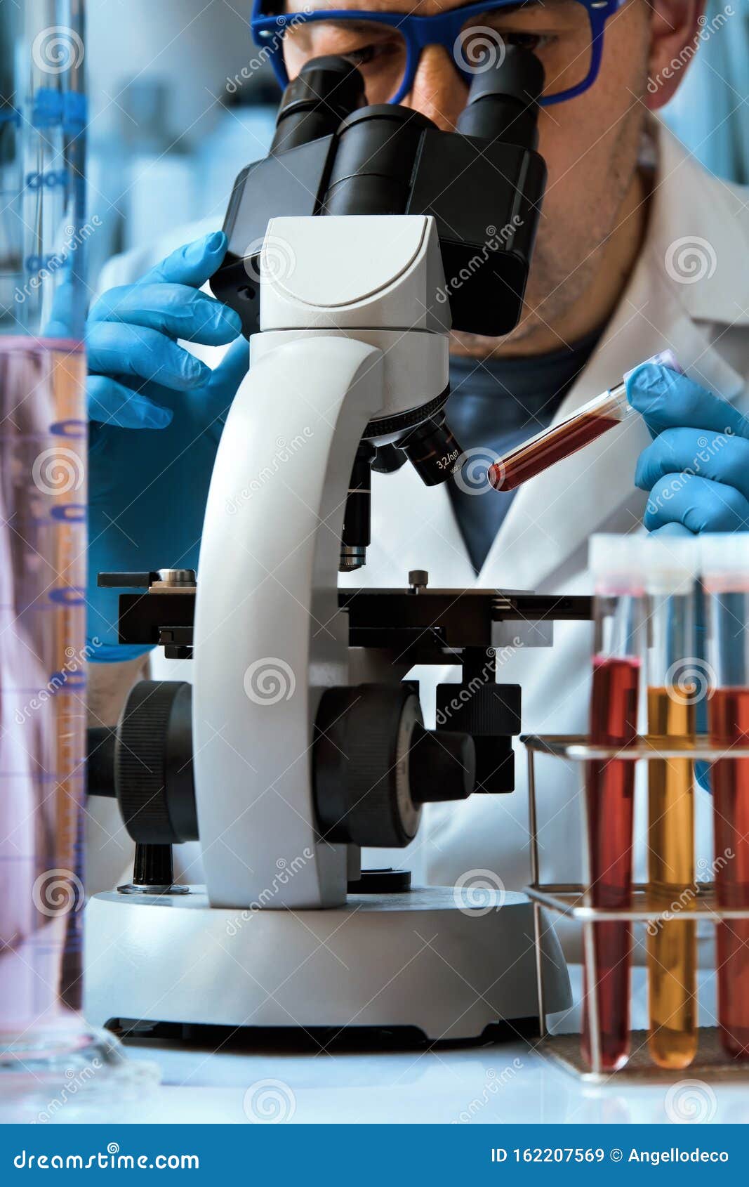Microscopist Holding a Blood Sample Tube for Analysis with the ...