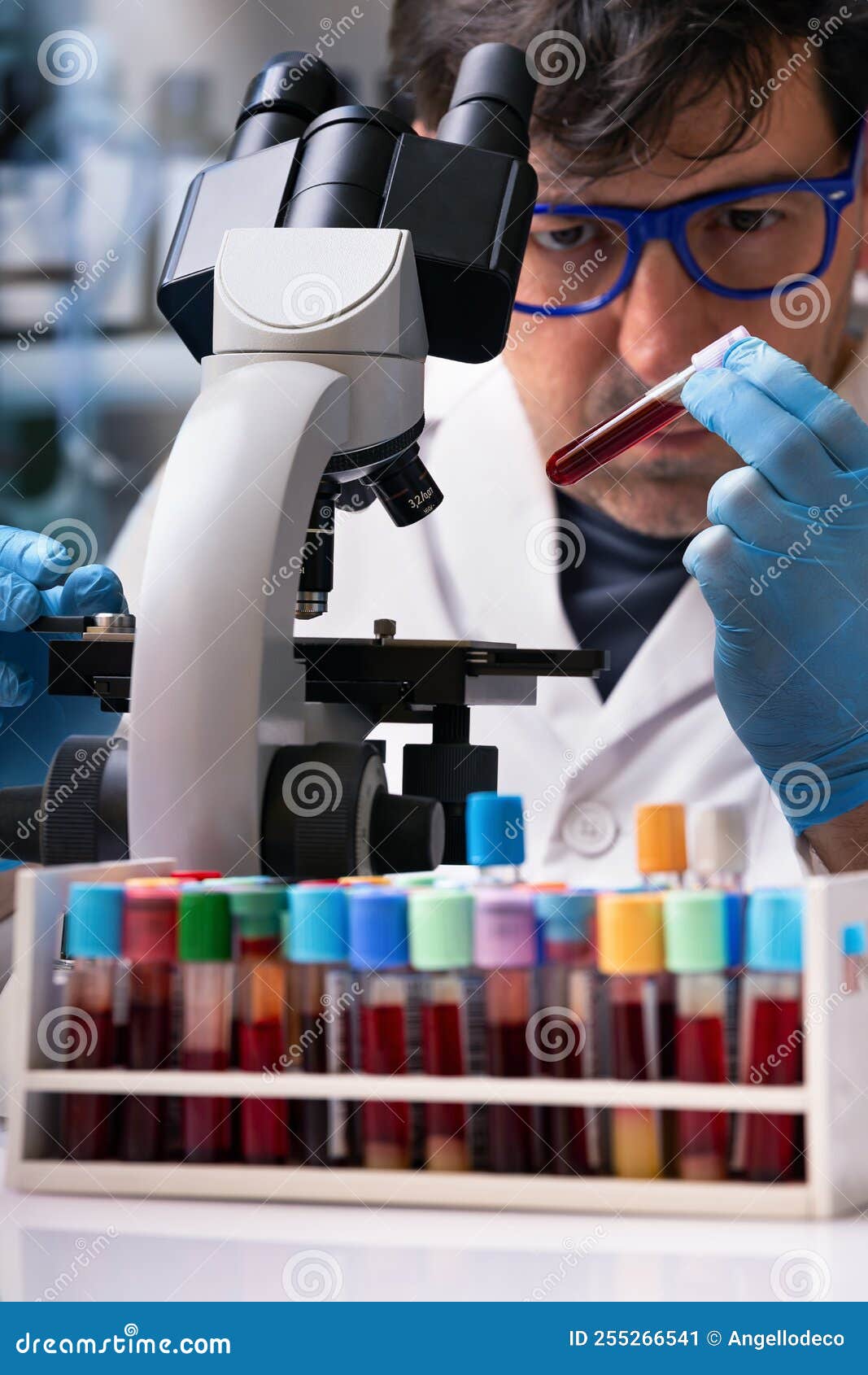 Microscopist Scientist Analyzing Blood Sample in Microscope in the ...