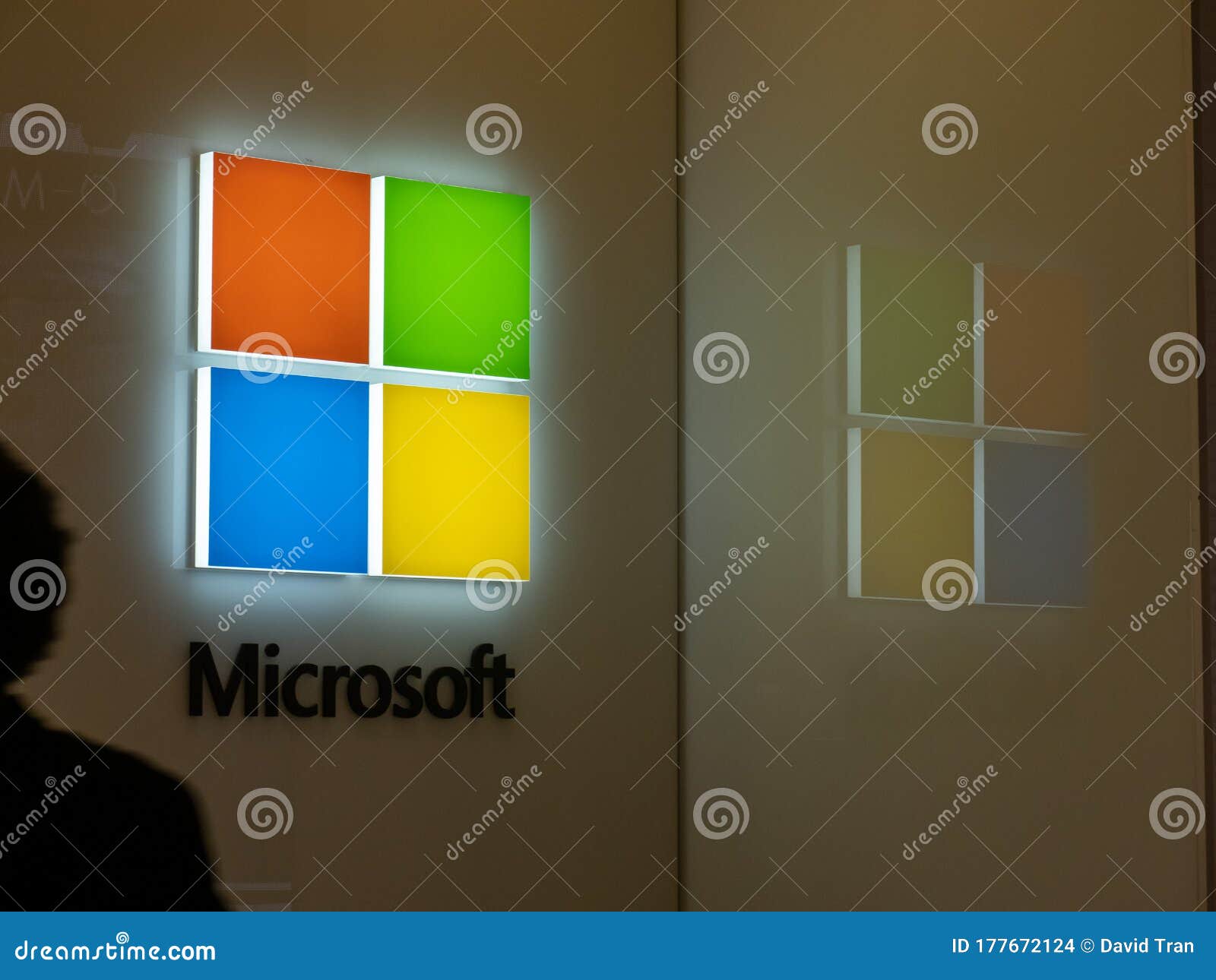 Microsoft Logo and Reflect with Man Walking by in Shadow Editorial ...