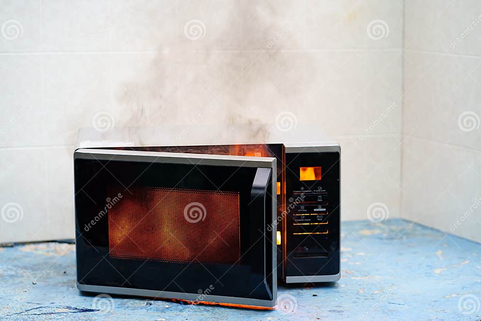 Microwave Oven on Fire. the Concept of Fire in the Kitchen. Stock Photo ...