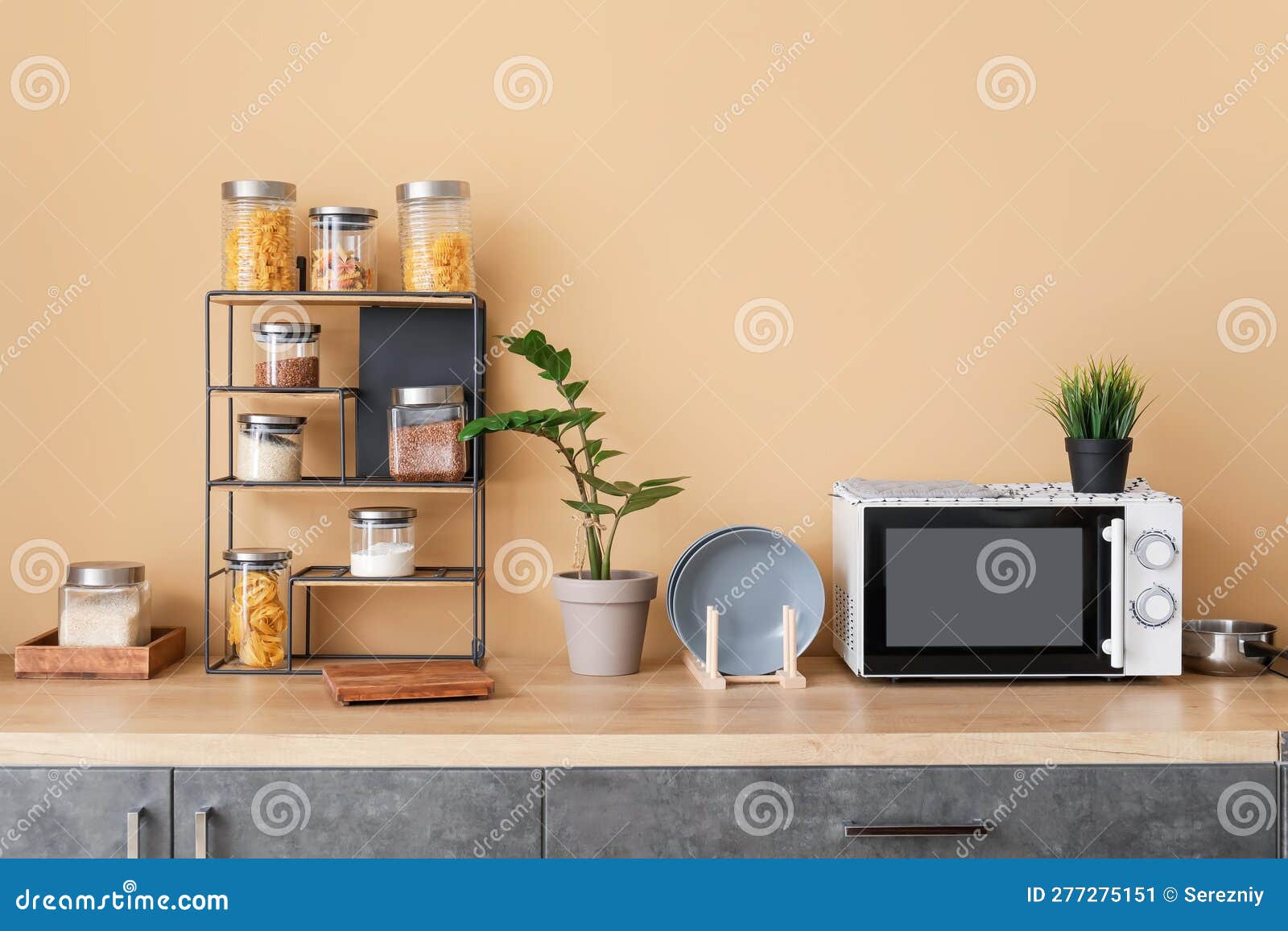 Microwave and Utensils on Table in Modern Kitchen Stock Image - Image ...