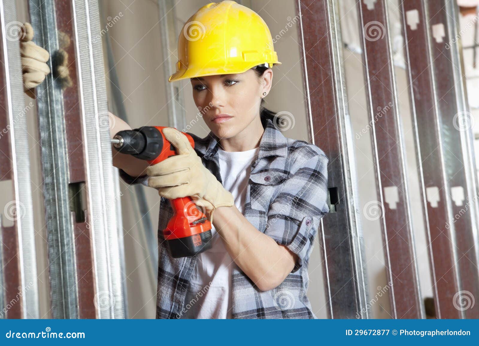 Mid Adult Female Contractor Drilling at Construction Site Stock Image ...