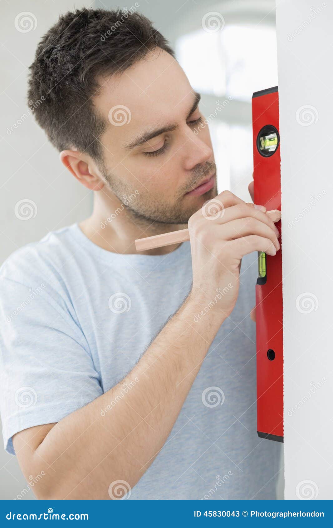 Mid-adult Man Marking on Wall with Level Stock Image - Image of holding ...