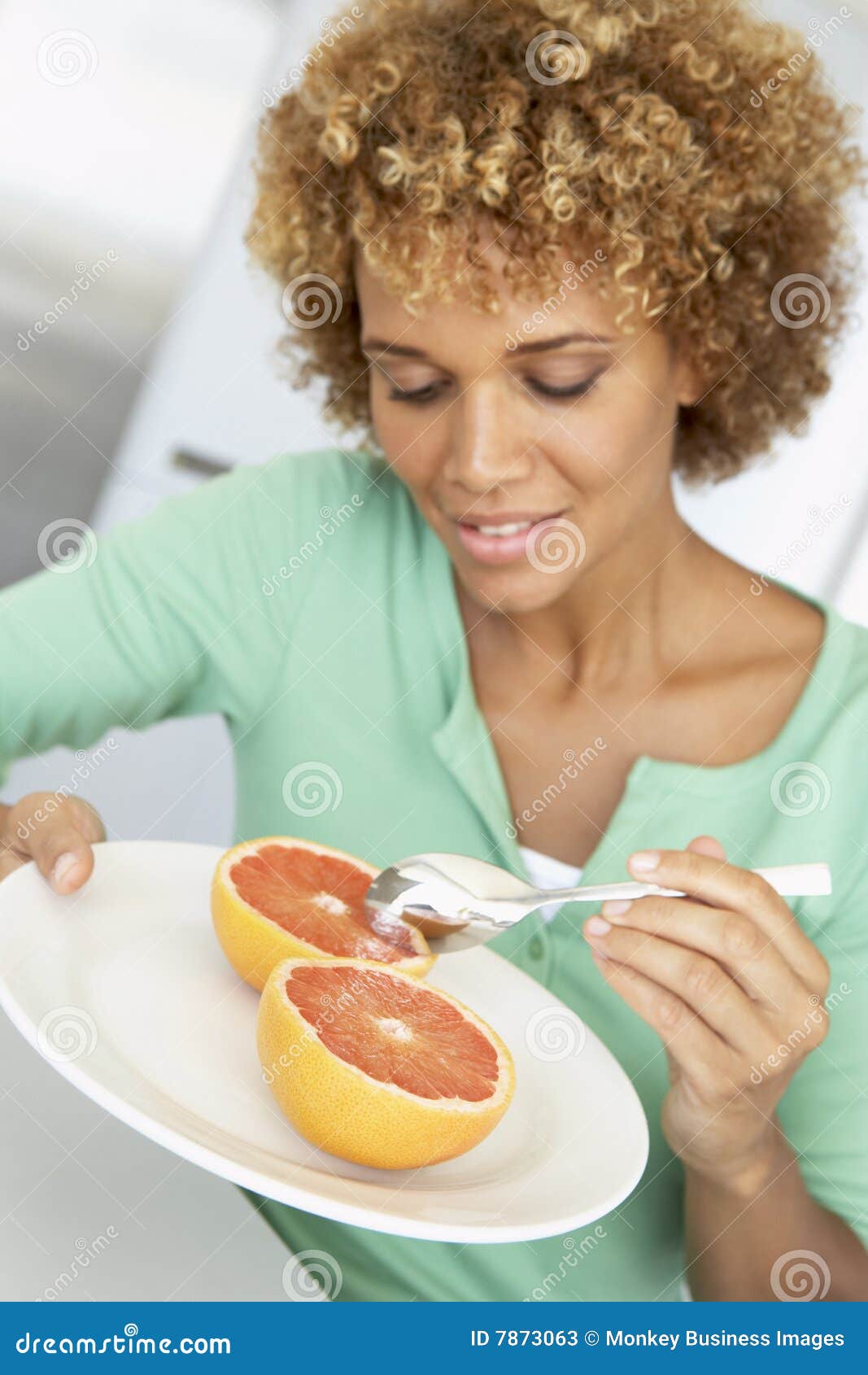 Mid Adult Woman Eating Fresh Grapefruit Stock Image - Image of kitchen ...