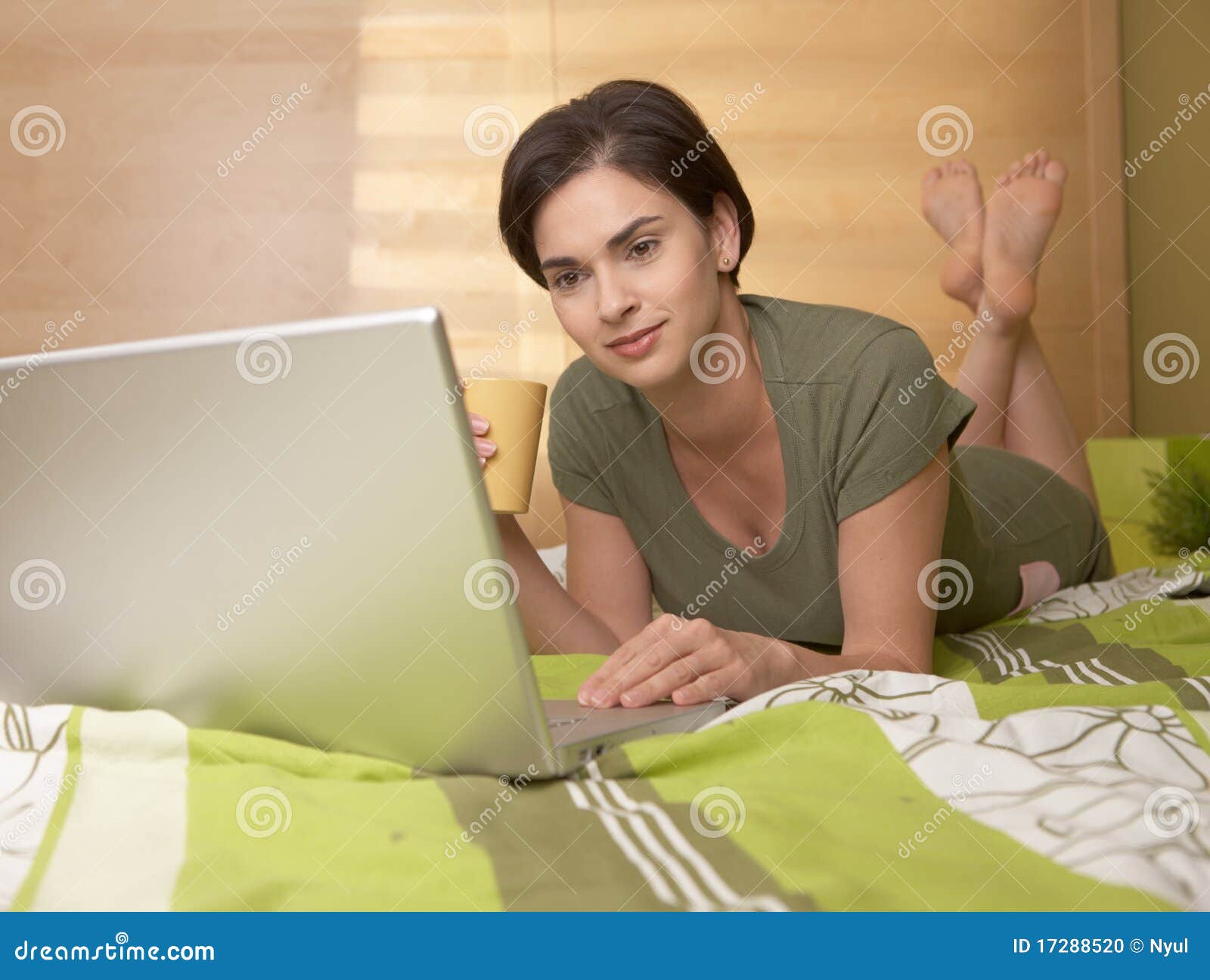 Mid-adult Woman Looking at Computer in Bed Stock Photo - Image of face ...