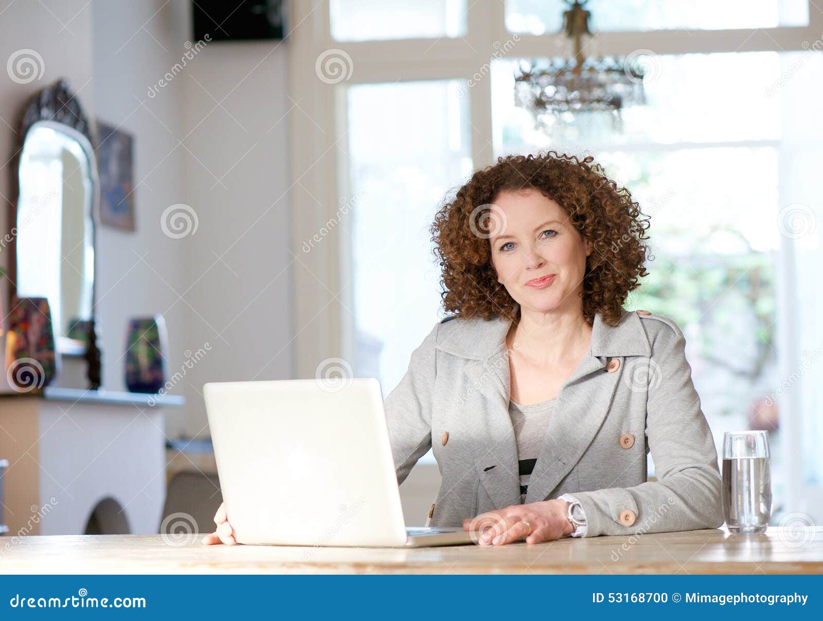 Mid Adult Woman Using Computer at Home Stock Photo - Image of confident ...