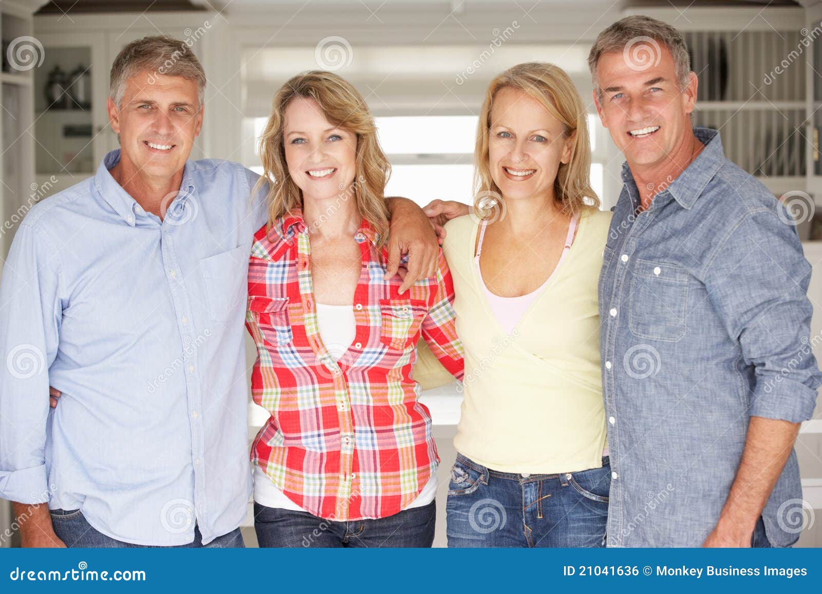 Mid age couples at home stock photo. Image of friends - 21041636
