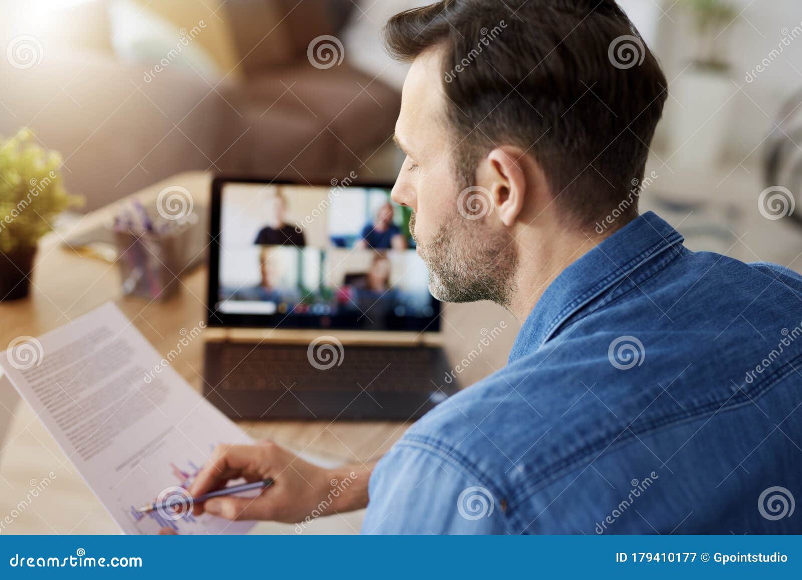 Man Analyzing Document and Having a Video Conference Stock Image ...