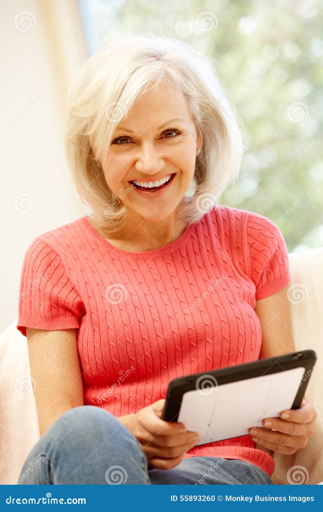 Mid Age Woman Using Tablet at Home Stock Photo - Image of networking ...