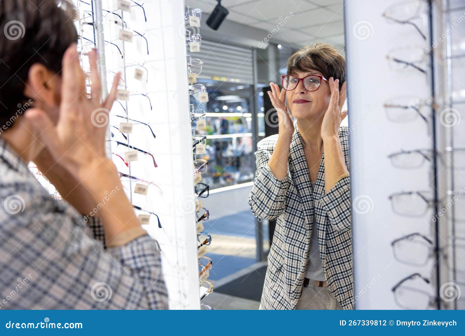 Mid Aged Good-looking Lady Trying on Eyeglasses at the Optical Store ...