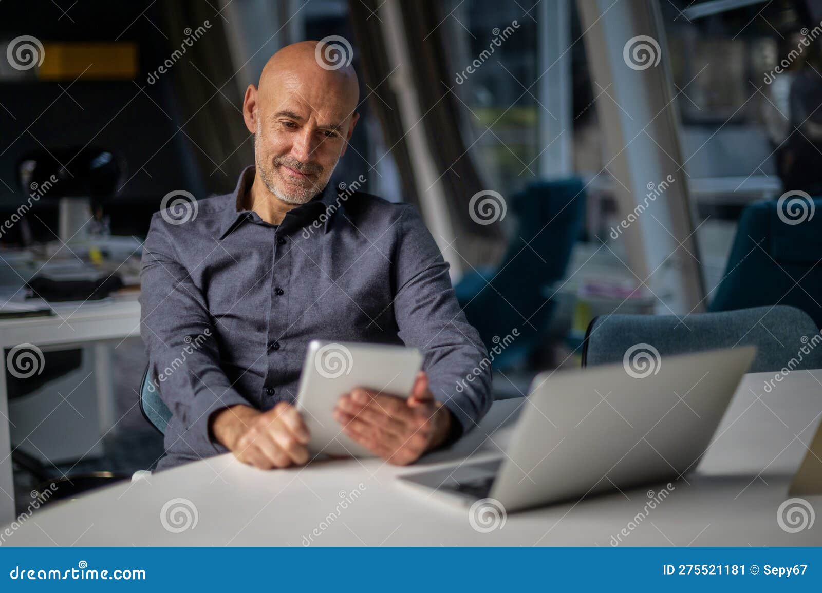 Mid Aged Professional Man Sitting at the Office and Using Touchpad and ...