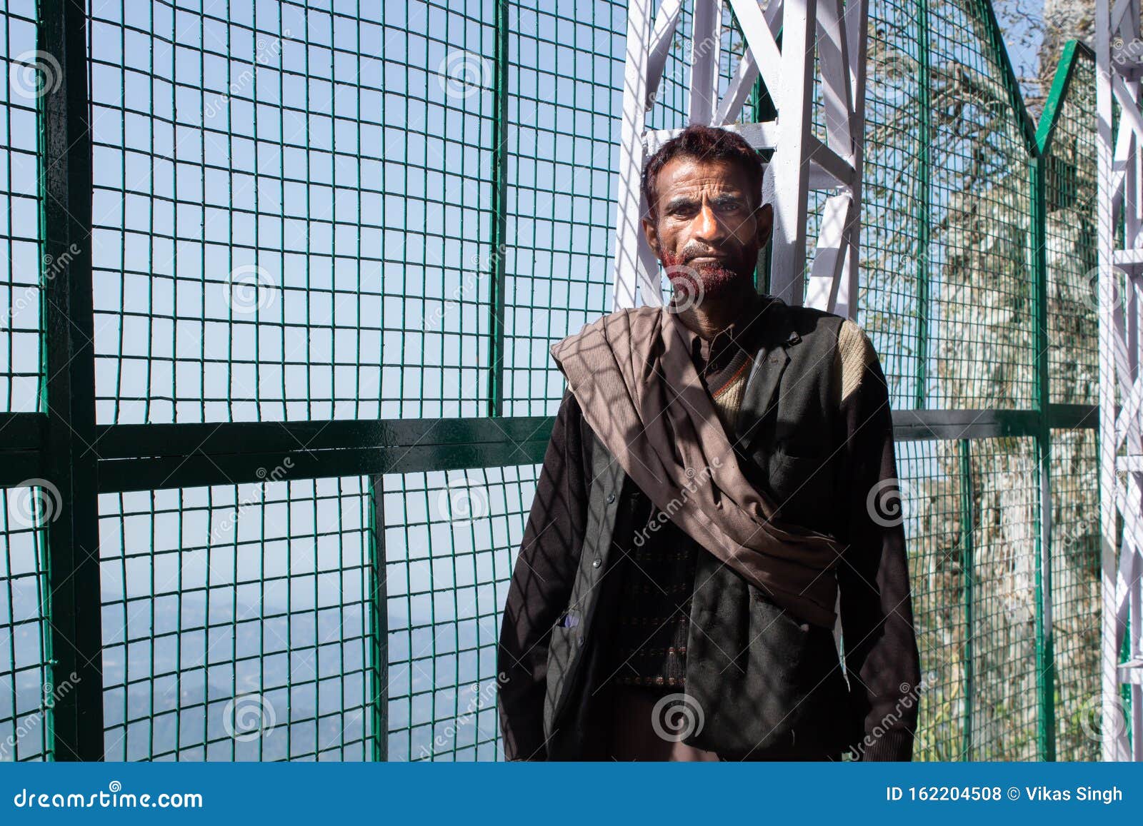 Mid Close Up Shot of a Poor Man Standing in the Sun Light for a ...