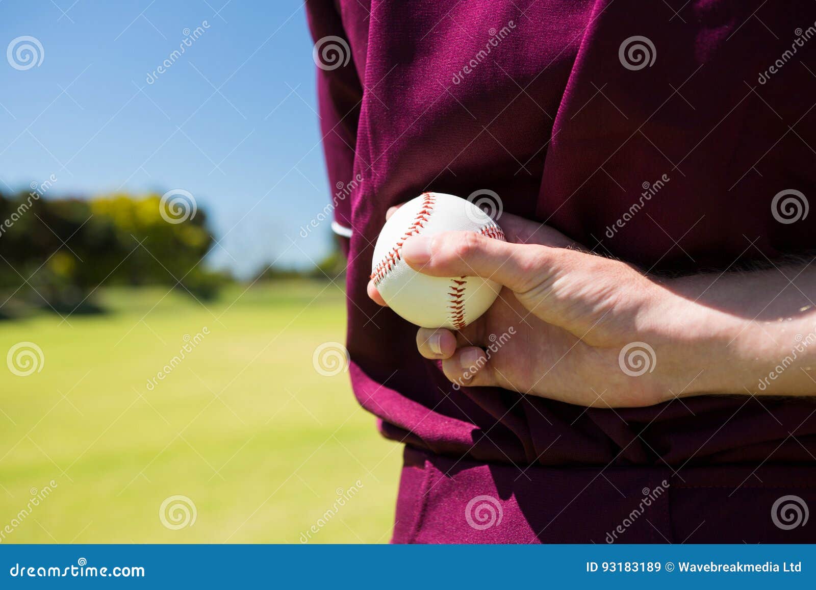 Mid Section of Baseball Player Holding Ball Behind Back Stock Image ...