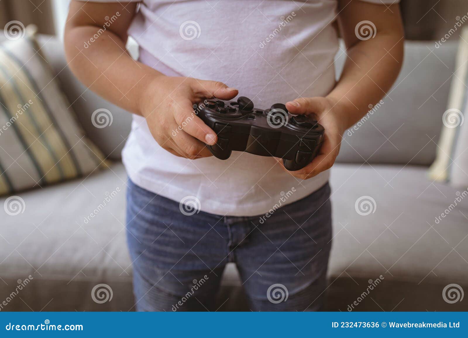 Mid Section of Caucasian Boy Holding Video Game Controller at Home ...