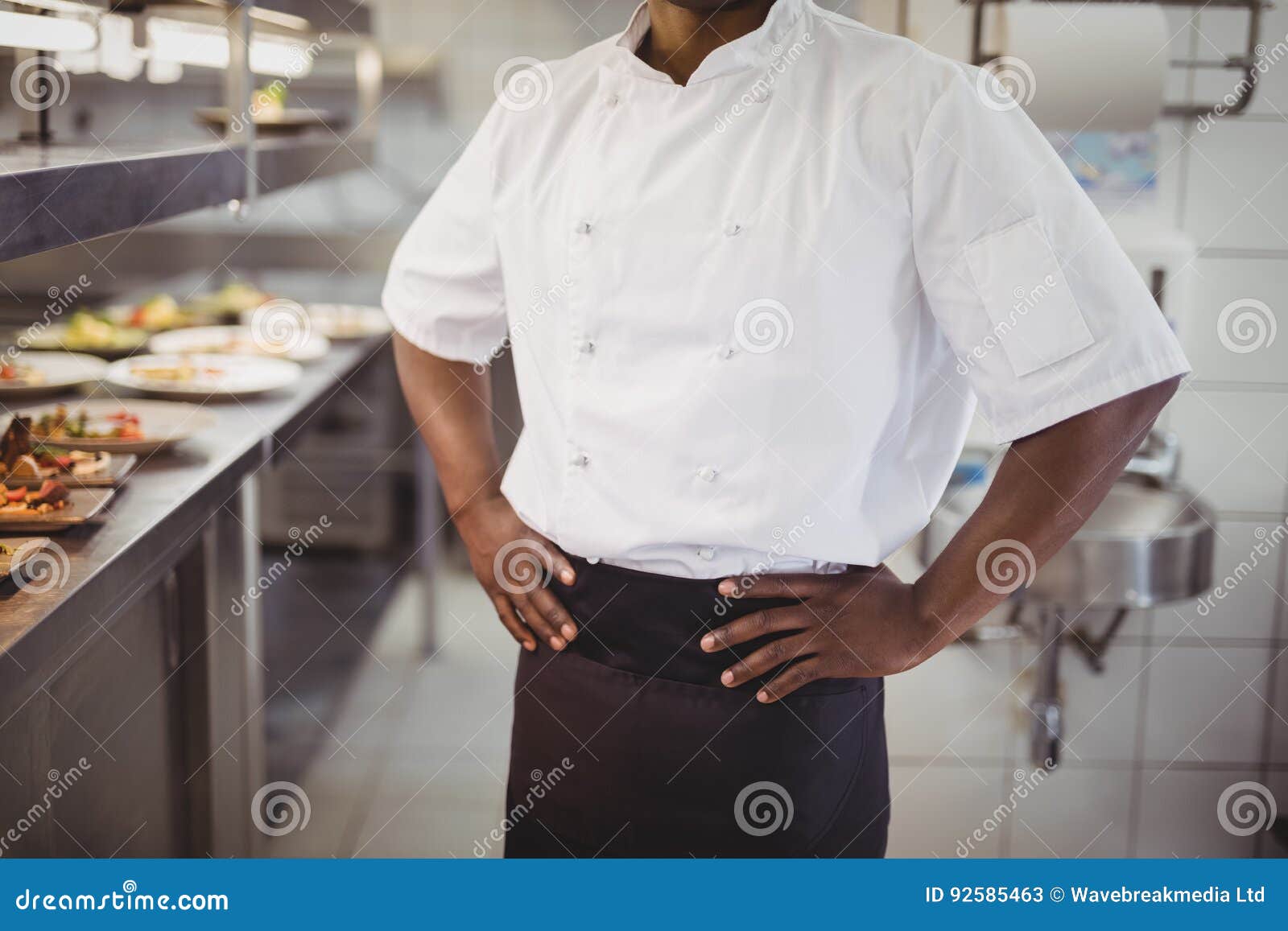 Mid Section of Chef Standing with Hands on Hip in Commercial Kitchen ...