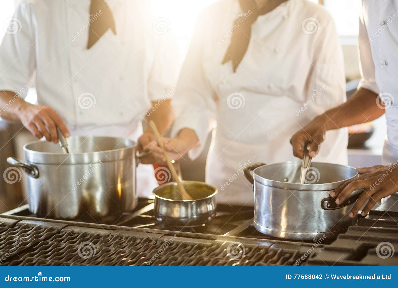 Mid Section of Chefs Stirring in Cooking Pot Stock Photo - Image of ...