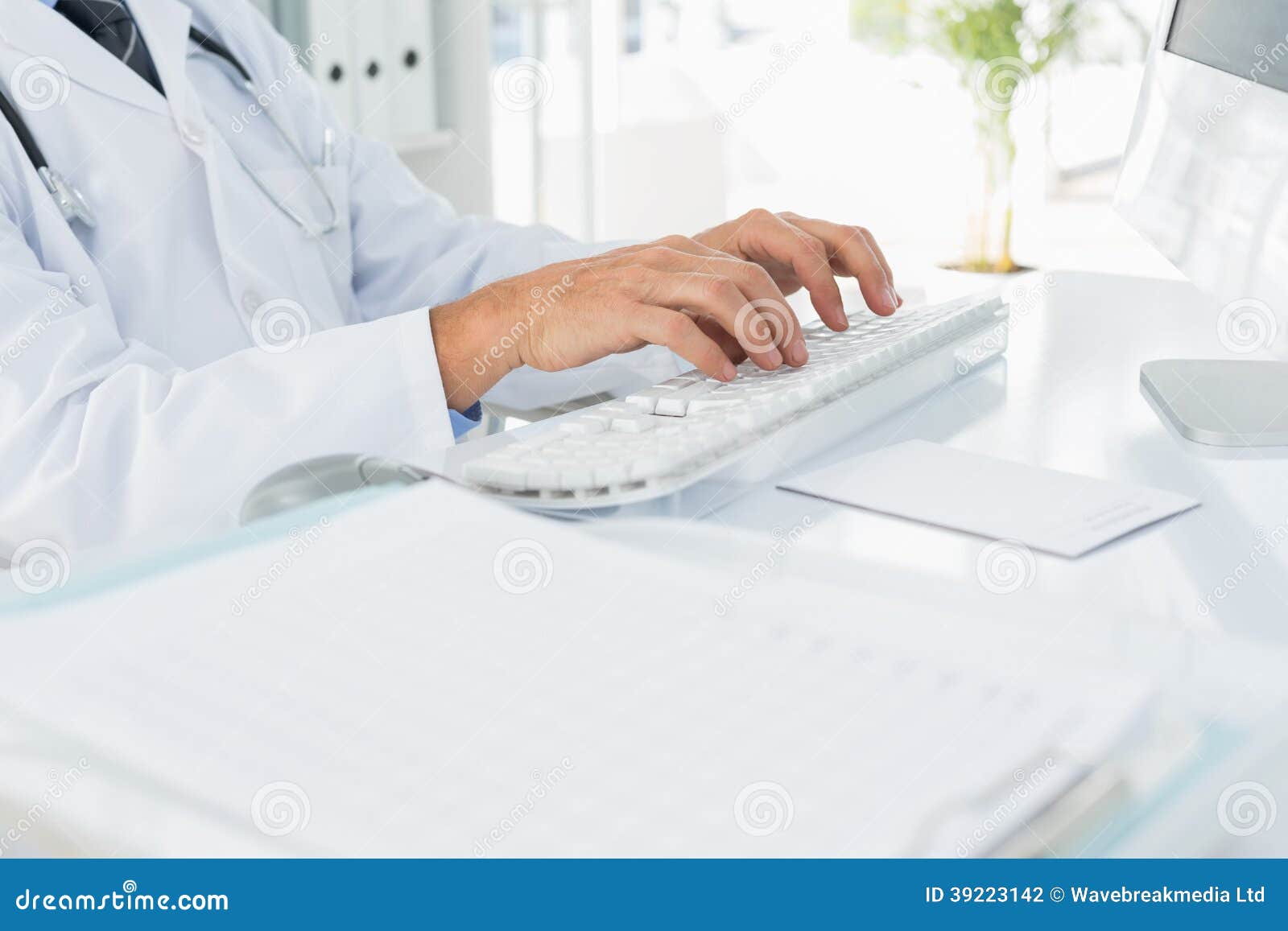 Mid Section of Doctor Using Computer Keyboard at Medical Office Stock ...