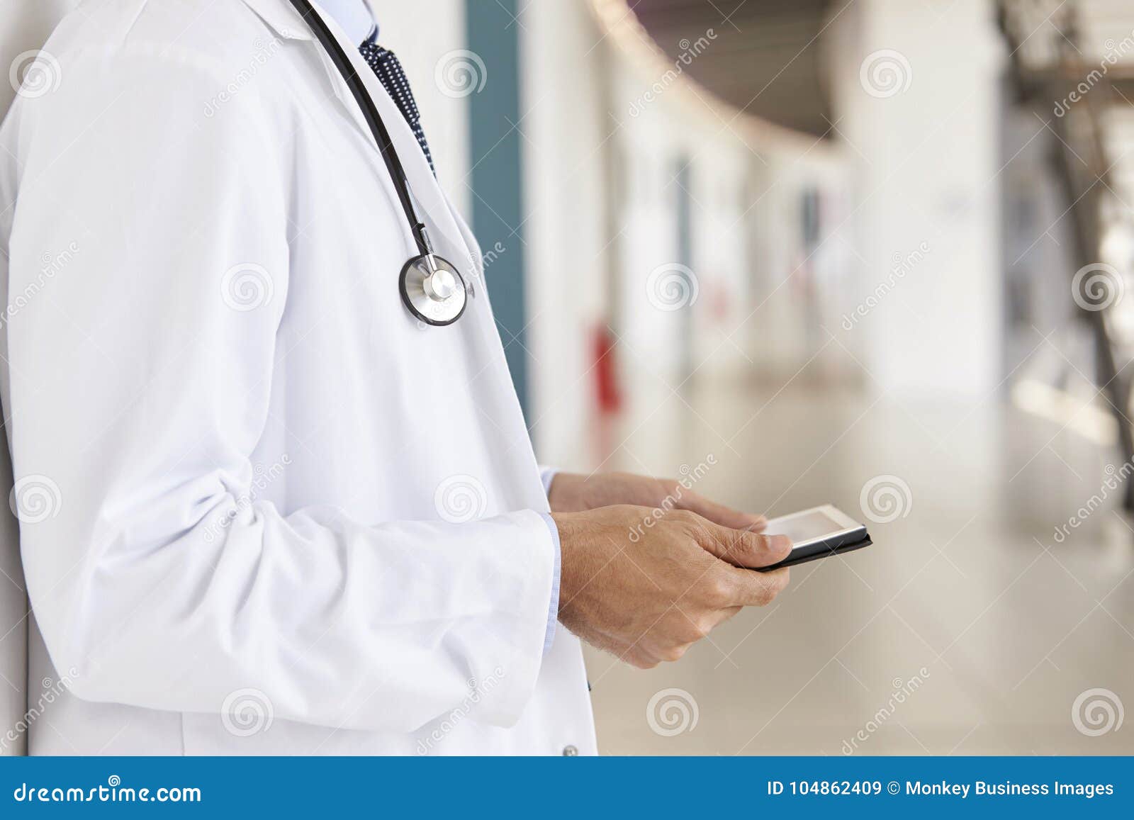 Mid Section of Doctor Using Tablet Computer in Corridor Stock Image ...