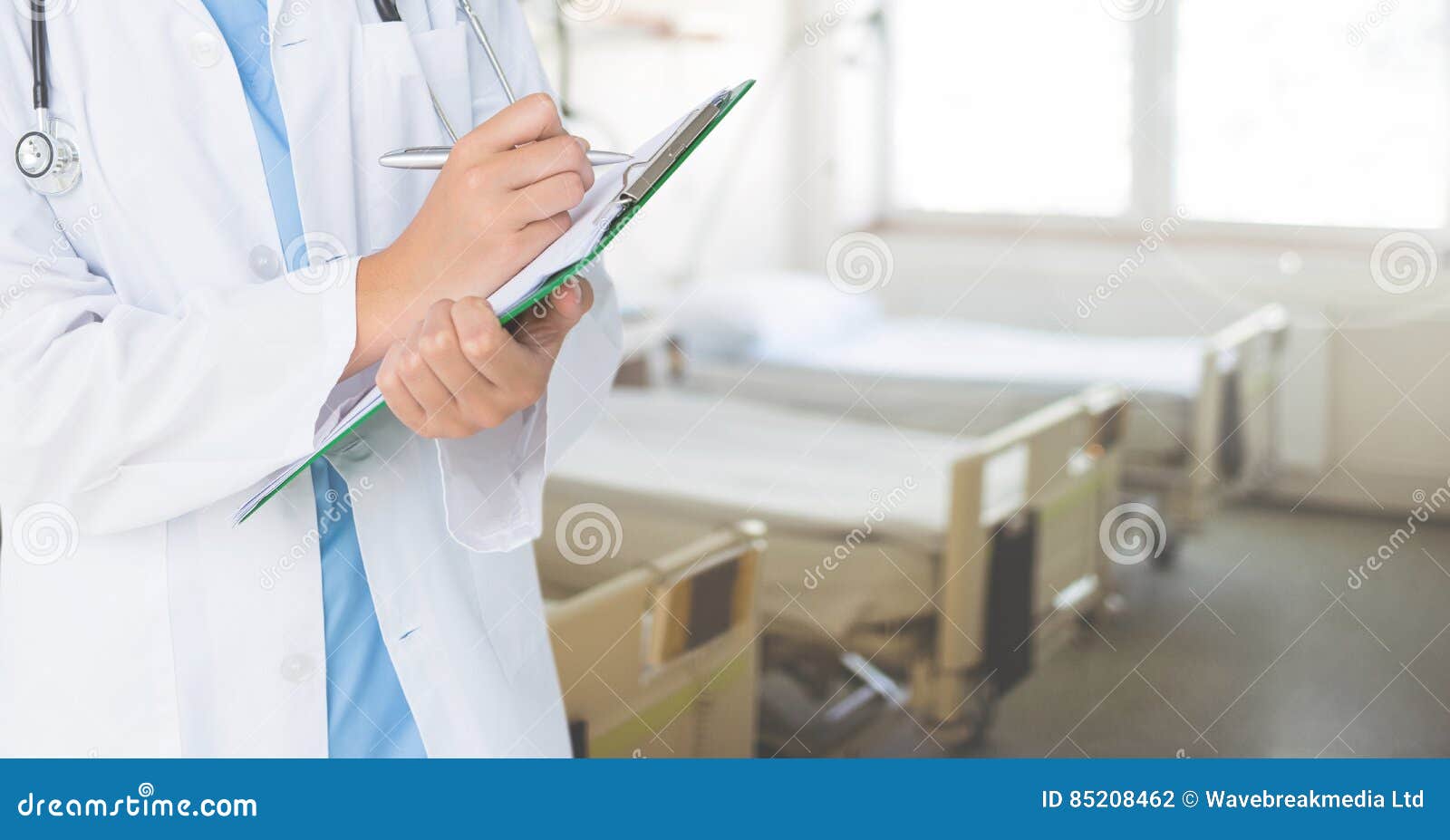 Mid Section of Doctor Writing on Clipboard Stock Photo - Image of ...