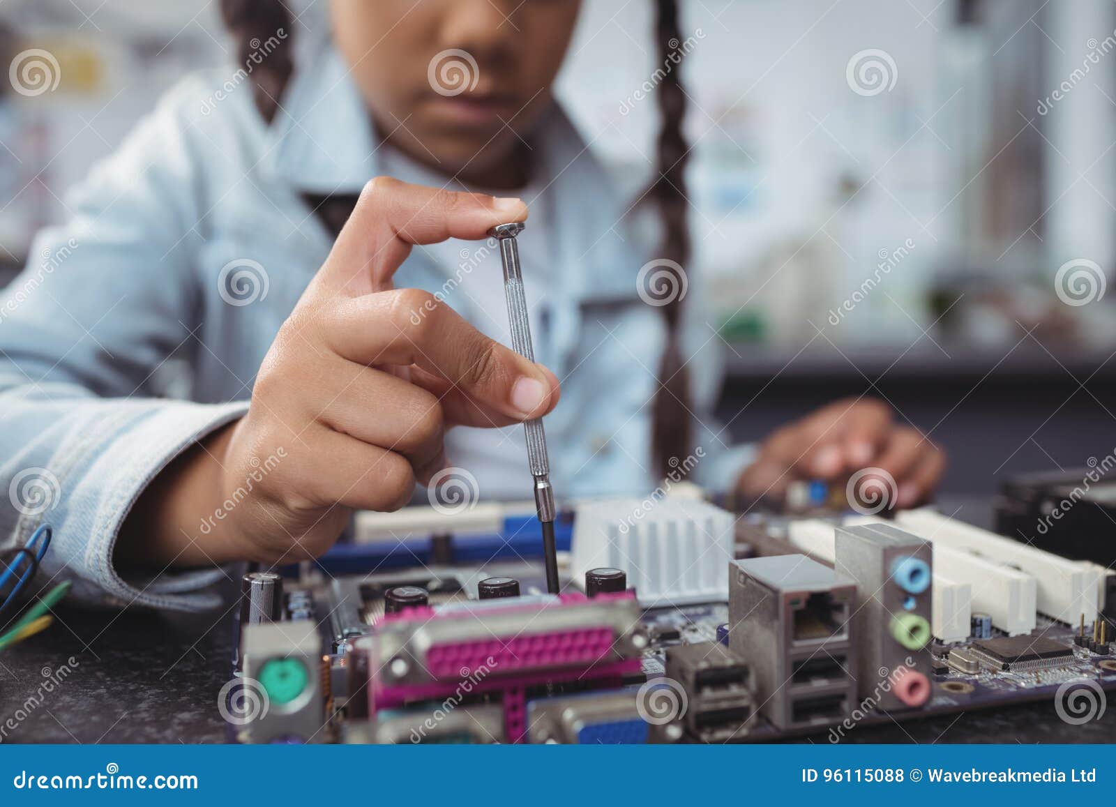 Mid Section of Elementary Girl Assembling Circuit Board Stock Photo ...