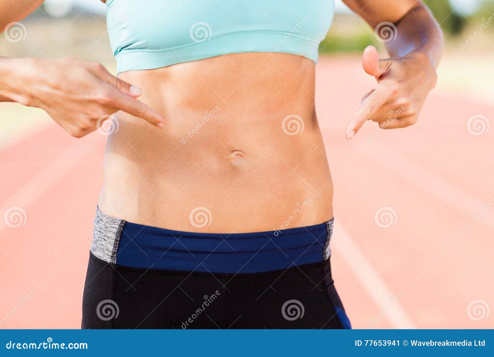 Mid Section of Female Athlete Pointing on Her Belly Stock Image - Image ...