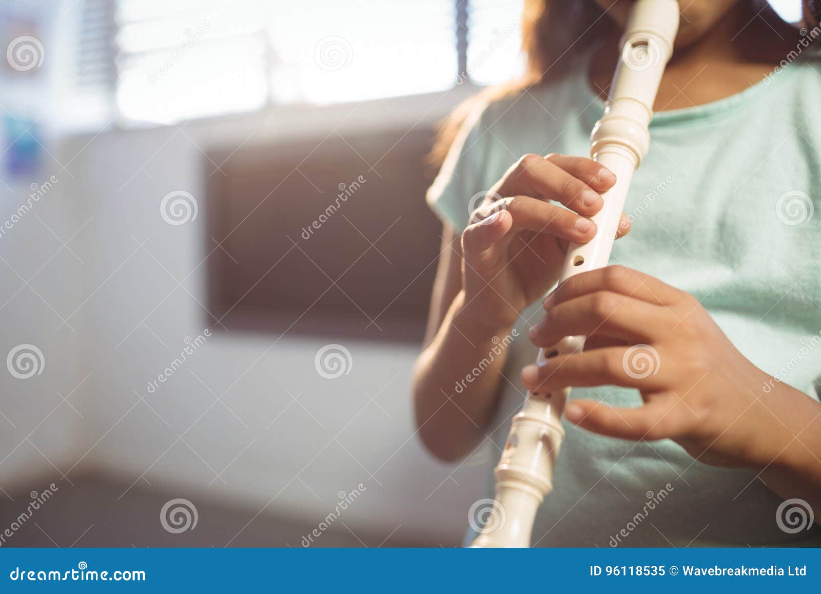 Mid Section of Girl Playing Flute in Classroom Stock Image - Image of ...