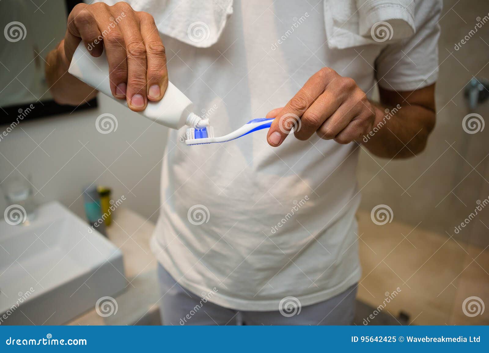 Mid-section of Man Putting Toothpaste on Toothbrush Stock Image - Image ...