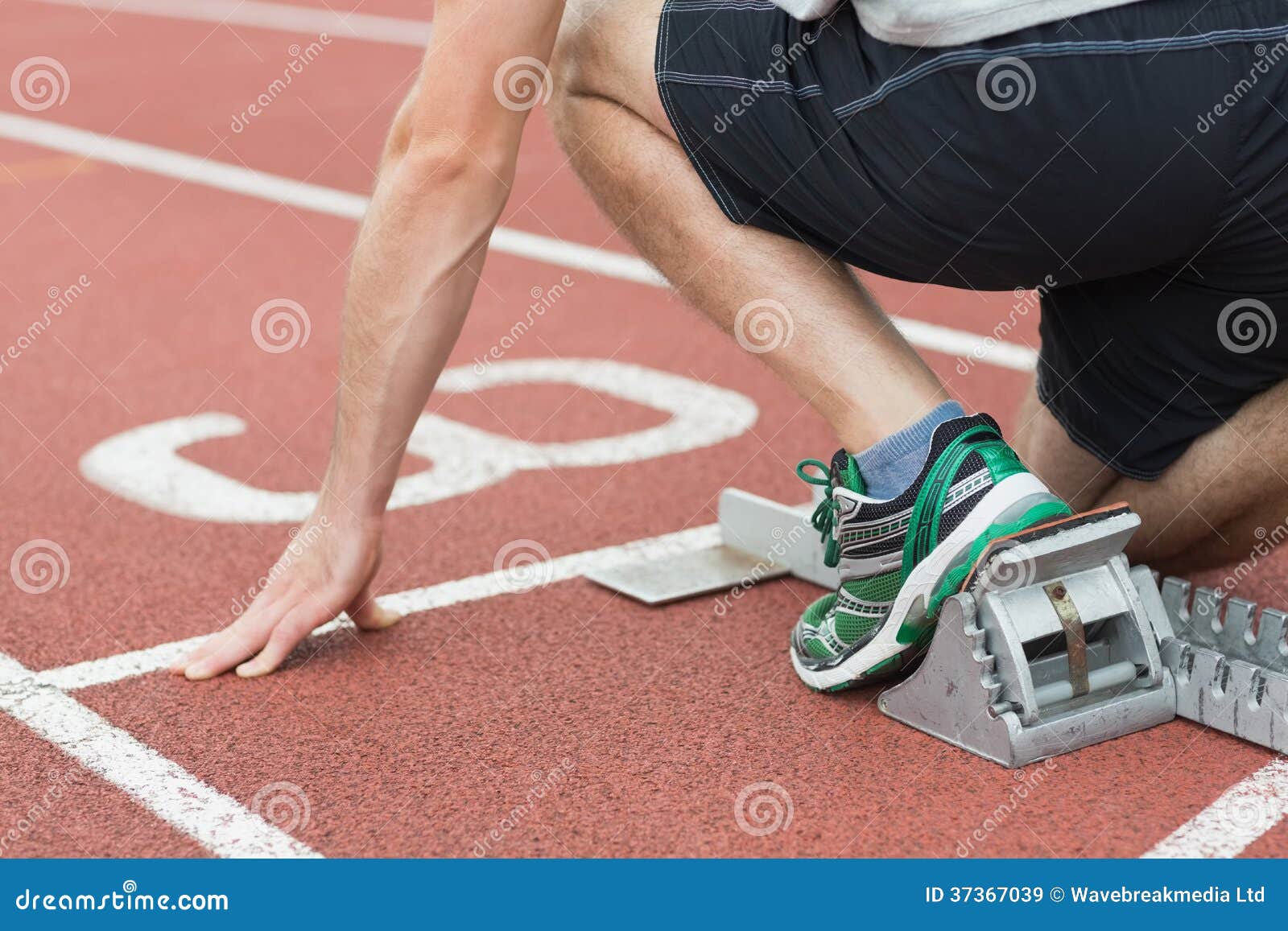 Mid Section of a Man Ready To Race on Running Track Stock Image - Image ...