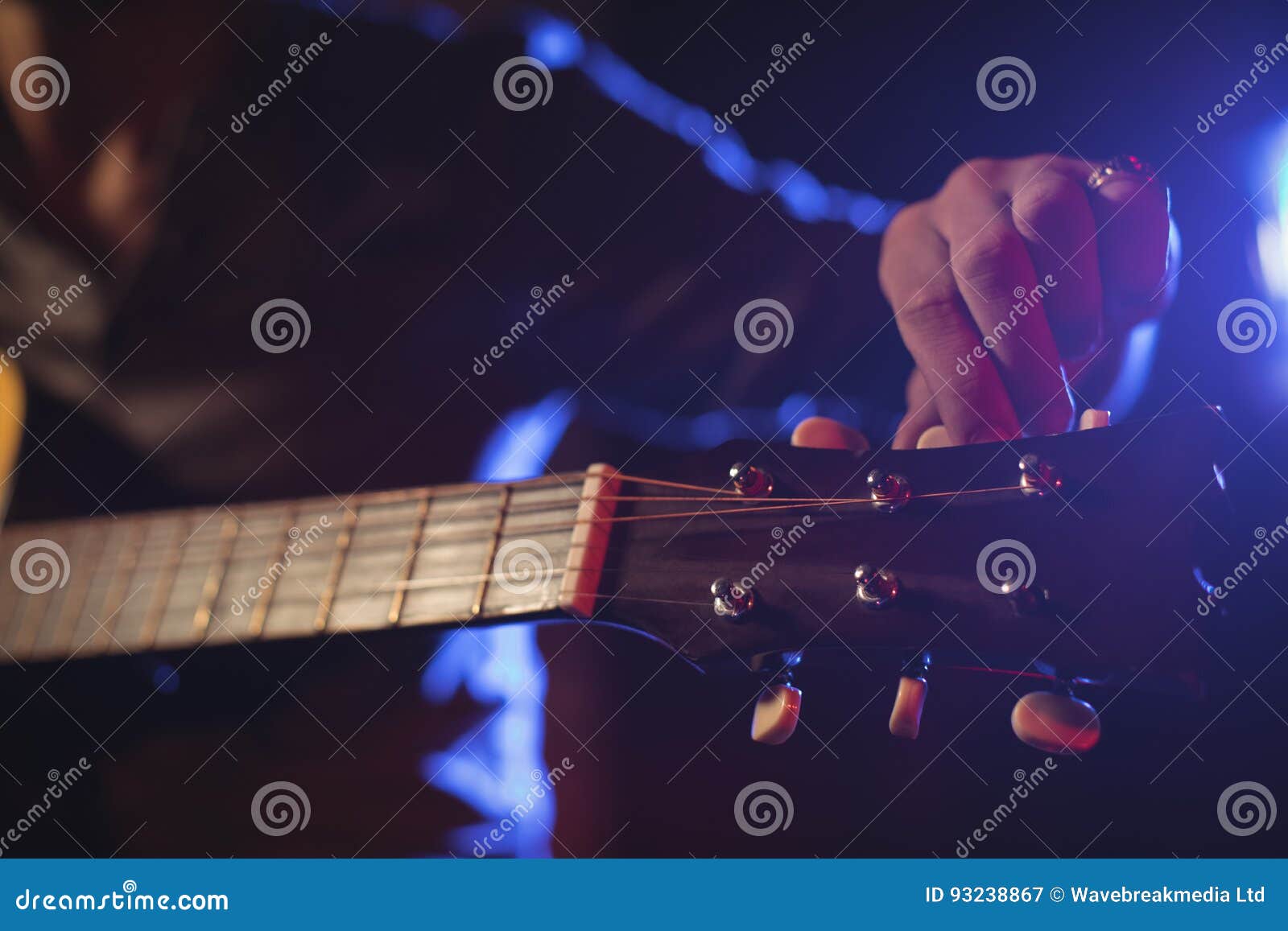 Mid Section of Musician Adjusting Tuning Peg Stock Image - Image of ...