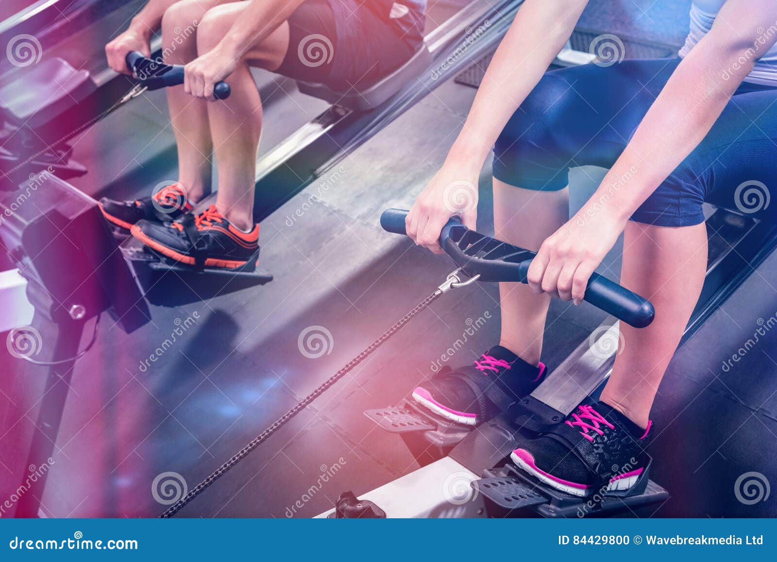 Mid Section of People Exercising on Rowing Machine Stock Photo - Image ...