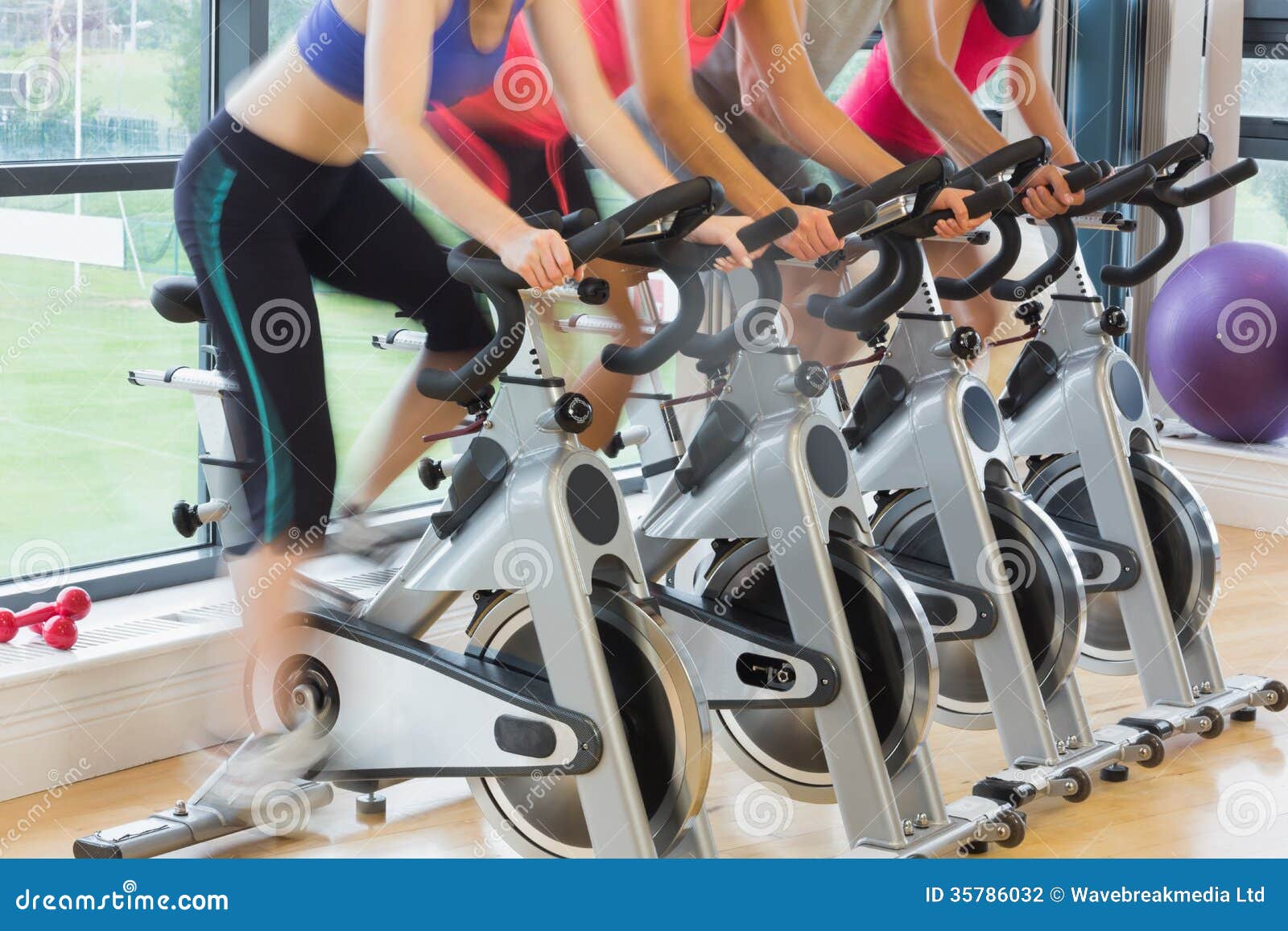 Mid Section Of People Working Out At Spinning Class Royalty-Free Stock ...
