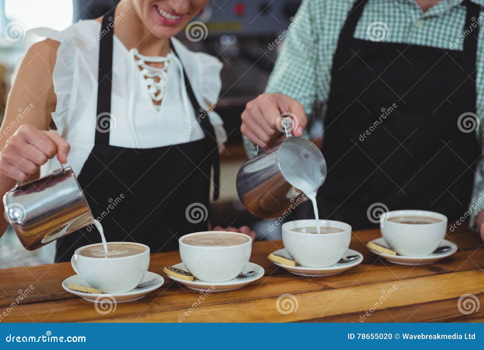 Mid Section of Waiter and Waitress Making Cup of Coffee at Counter ...