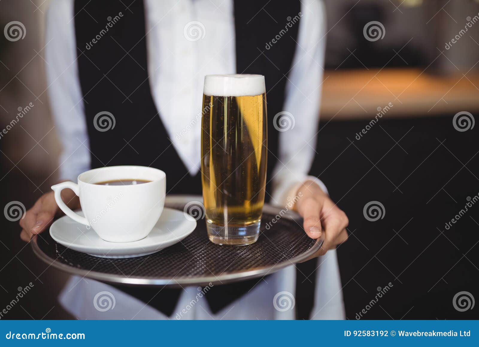 Mid-section of Waitress Holding Tray with Coffee and Beer Glass Stock ...