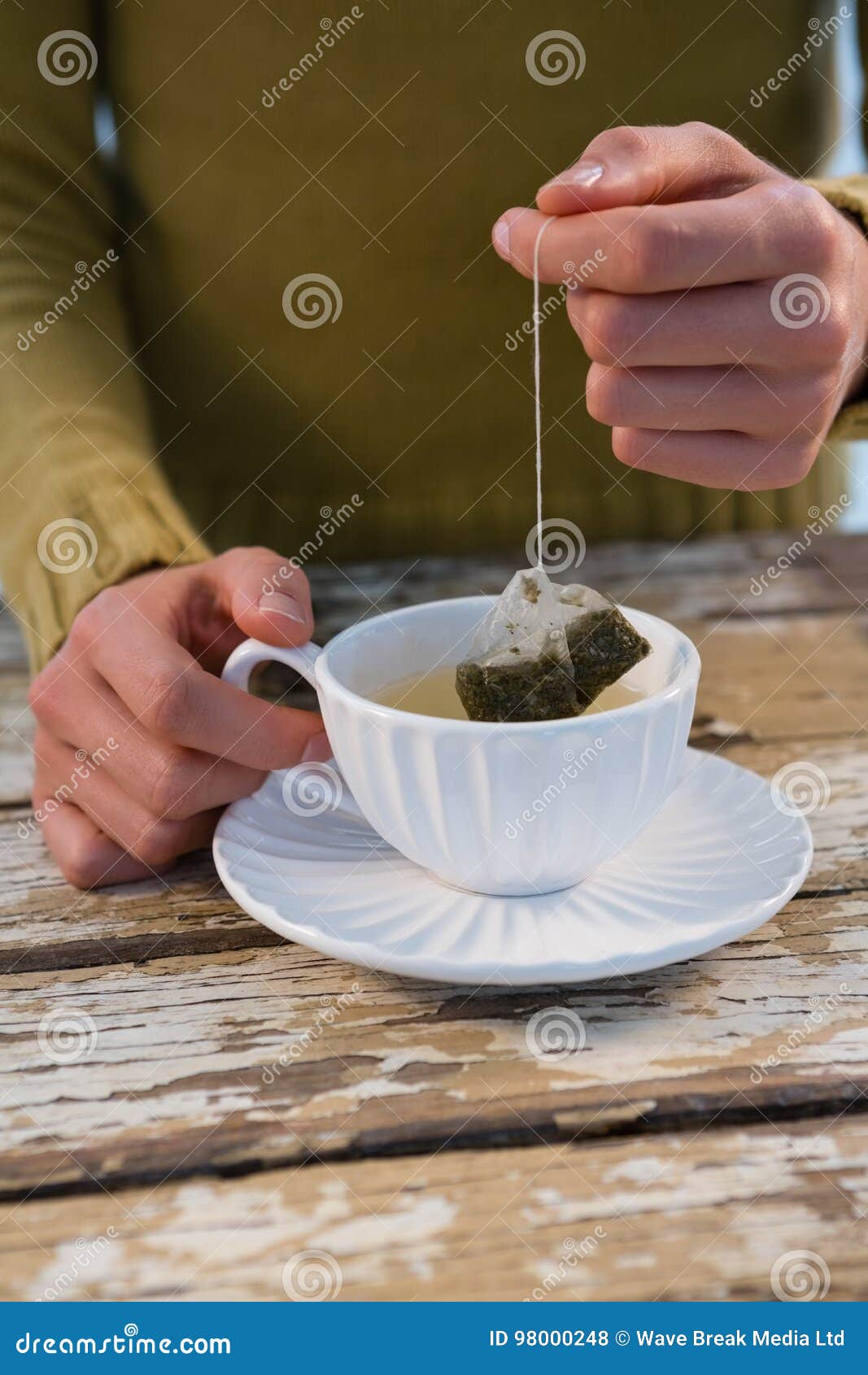 Mid Section of Woman Dipping Tea Bag in Cup Stock Photo - Image of ...