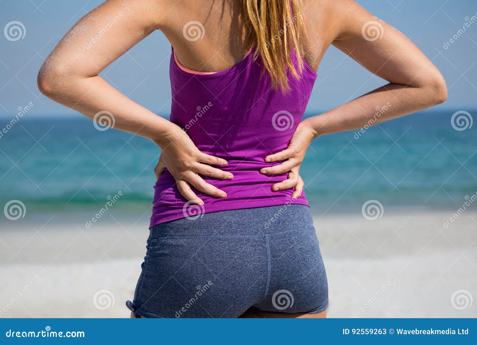 Mid Section of Woman Standing with Hands on Hip at Beach Stock Image ...