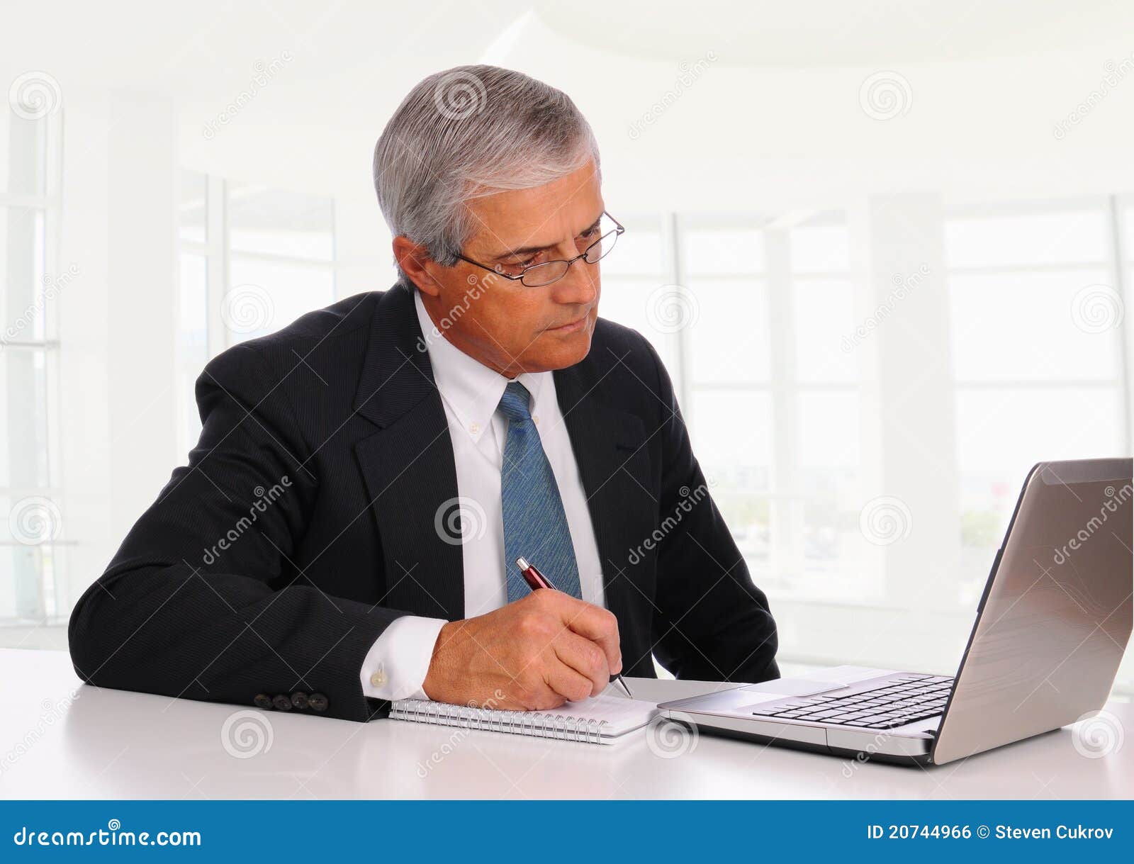 Middle Age Businessman at Desk with Laptop Stock Photo - Image of ...