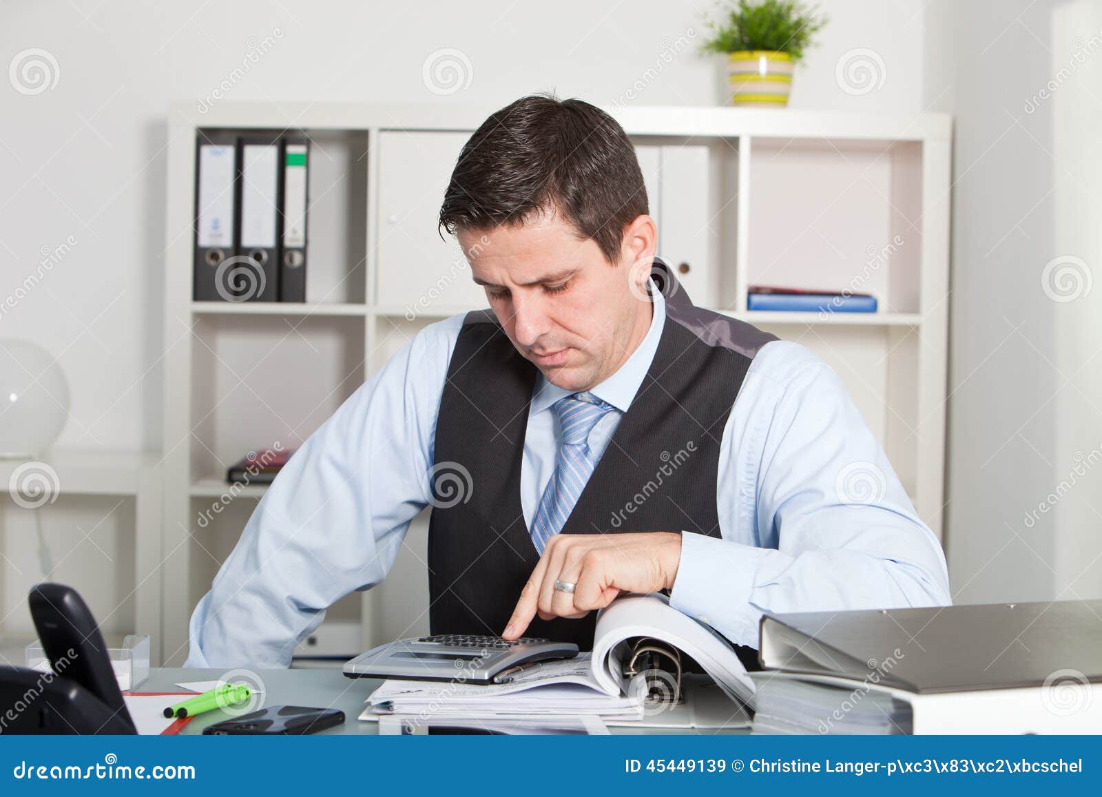 Middle Age Businessman Seriously Reading a Folder at the Table. Stock ...