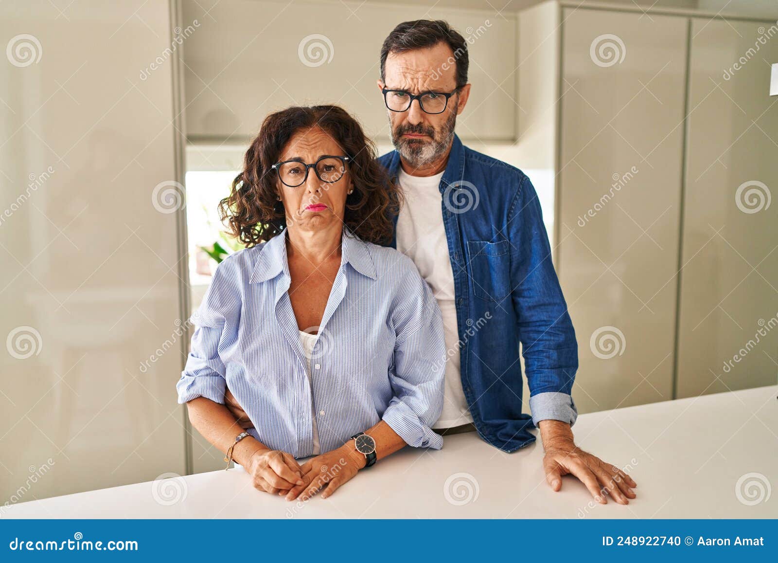 Middle Age Couple Standing Together Depressed and Worry for Distress ...