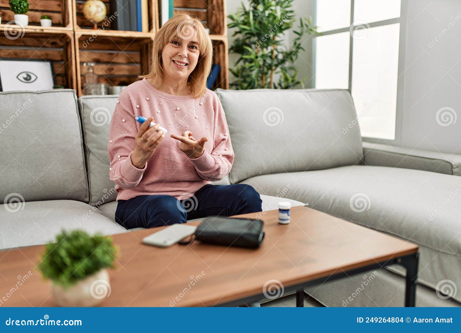 Middle Age Diabetic Woman Measuiring Glucose Using Glucometer at Home ...