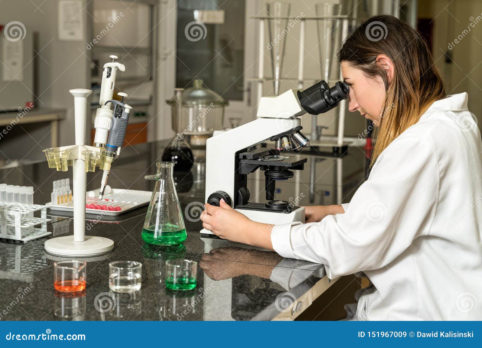 Middle Age Female Laboratory Technician Working on Compound Microscope ...