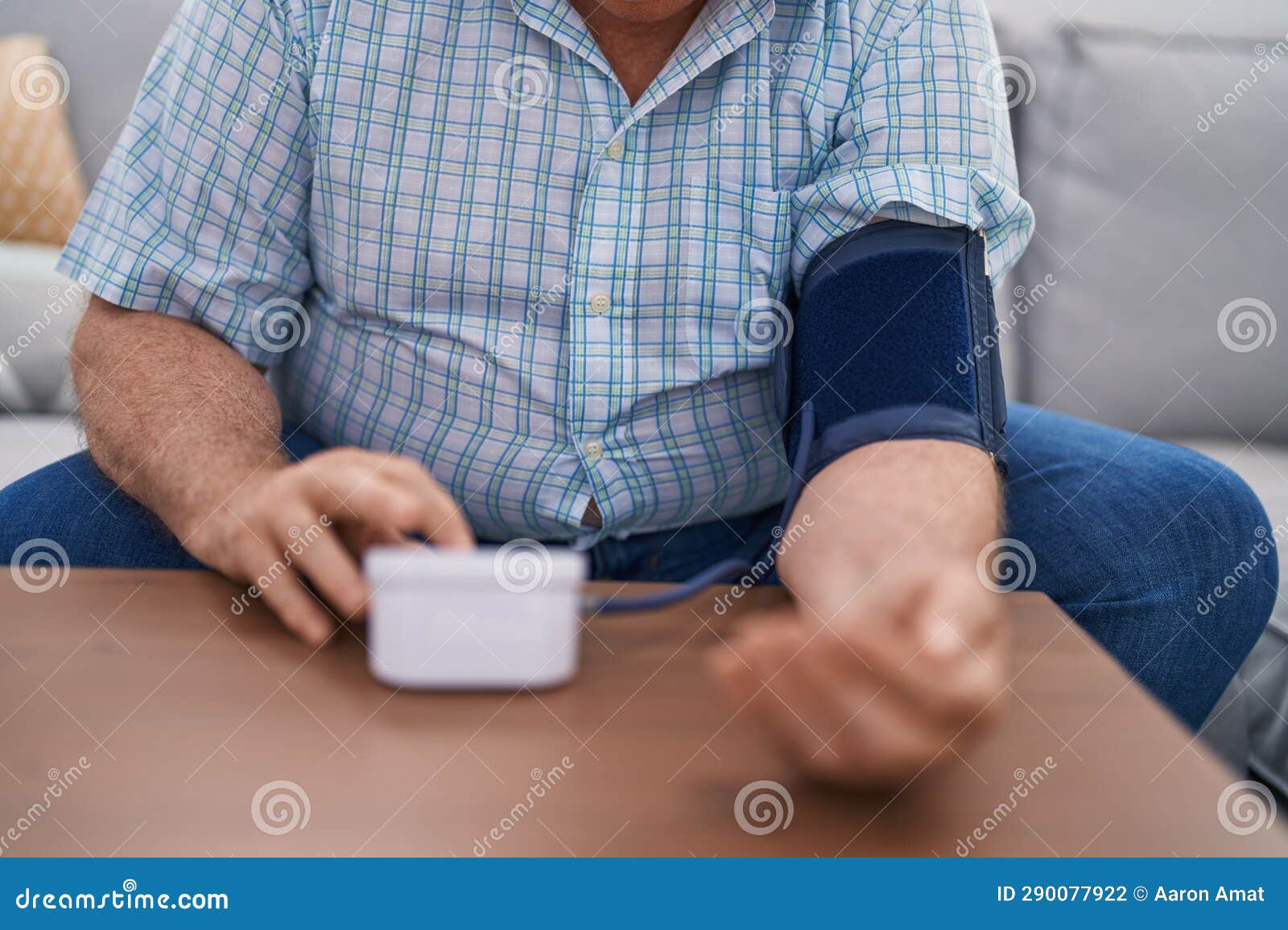 Middle Age Grey-haired Man Measuring Pulse Using Tensiometer at Home ...