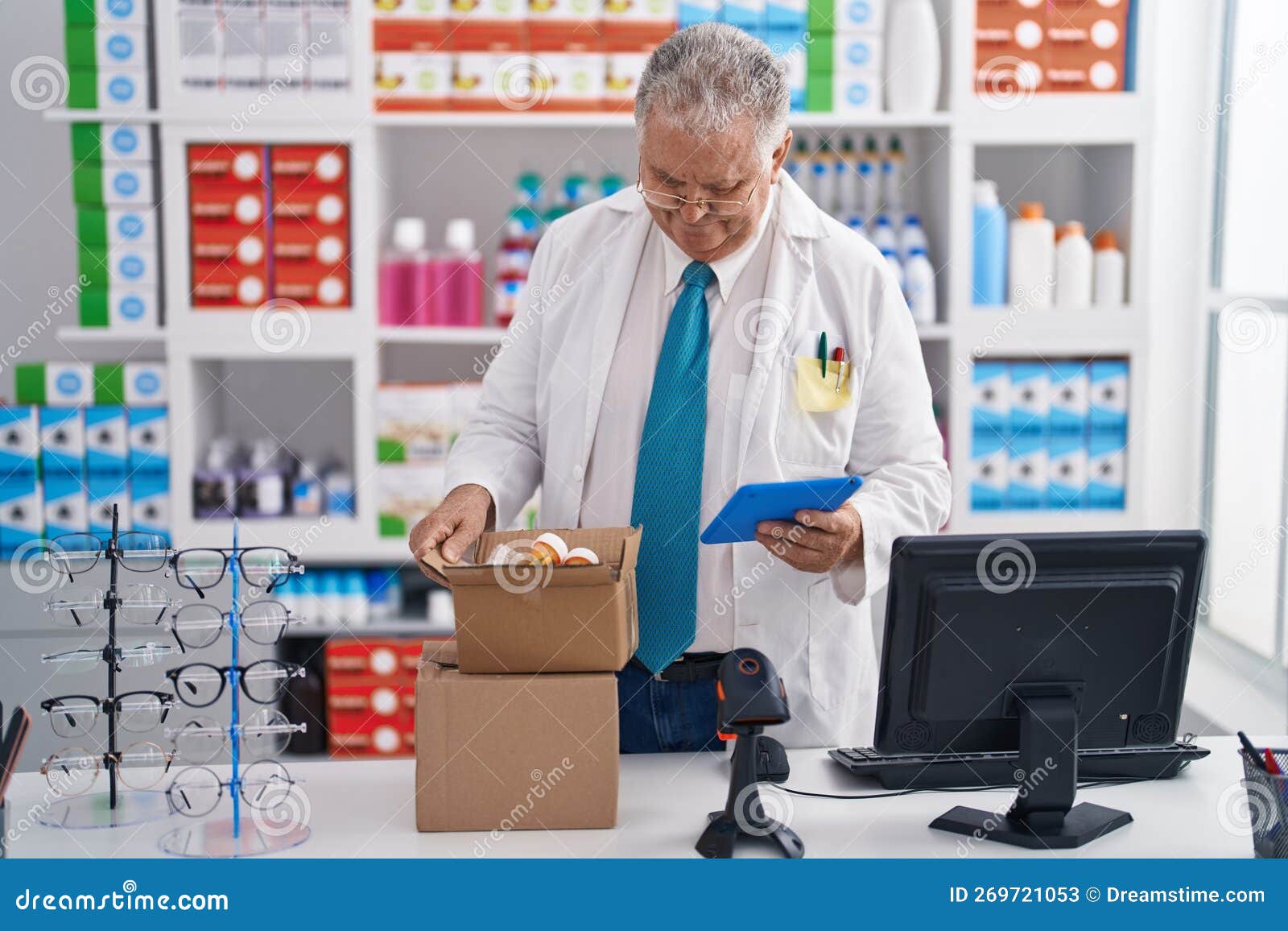 Middle Age Grey-haired Man Pharmacist Using Touchpad Holding Pills ...
